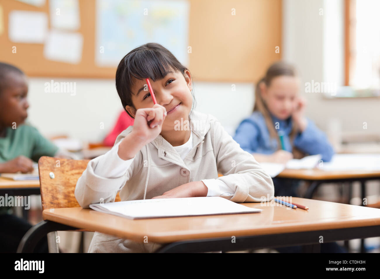 Girl scratching her forehead with pen Stock Photo - Alamy
