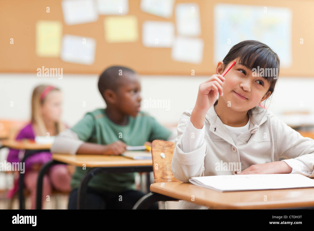 Thinking girl sitting in class Stock Photo - Alamy