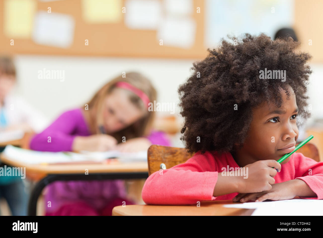Thinking girl in class Stock Photo - Alamy