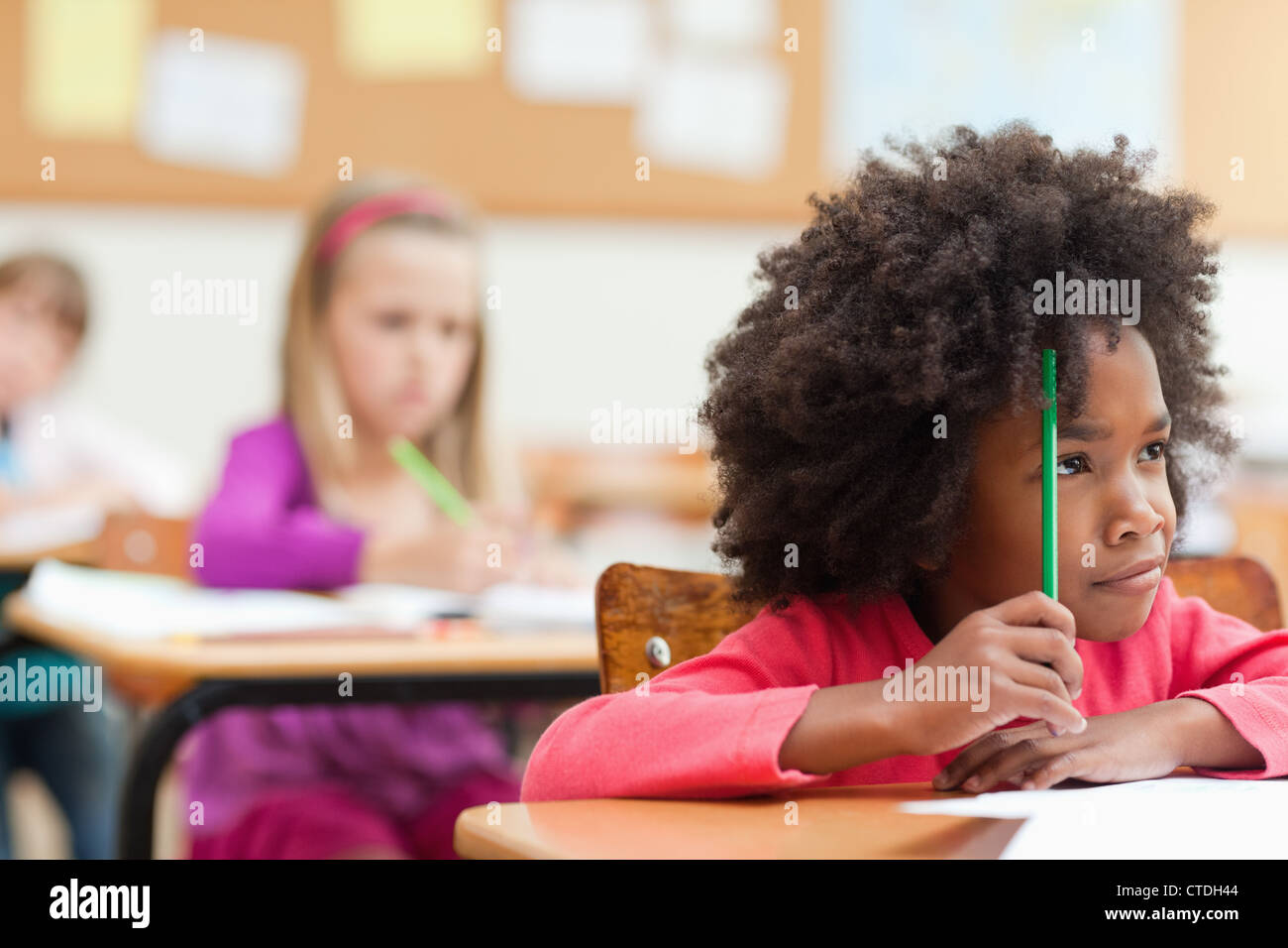 Thoughtful girl sitting in class Stock Photo - Alamy