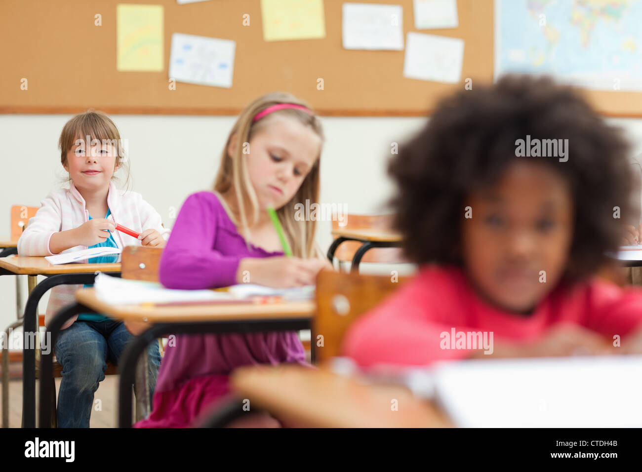 Girls sitting in class Stock Photo - Alamy