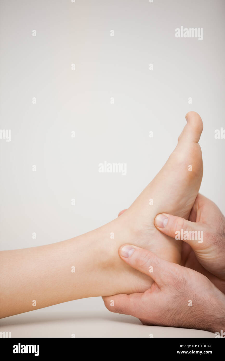 Two thumbs being placed on the side of a foot Stock Photo - Alamy