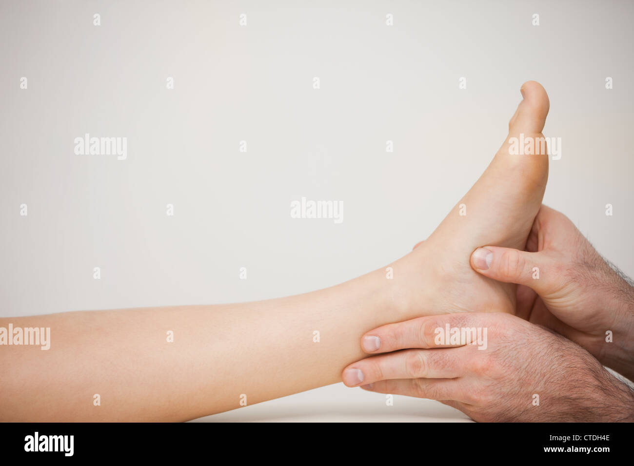 Chiropodist massaging foot patient hi-res stock photography and images ...