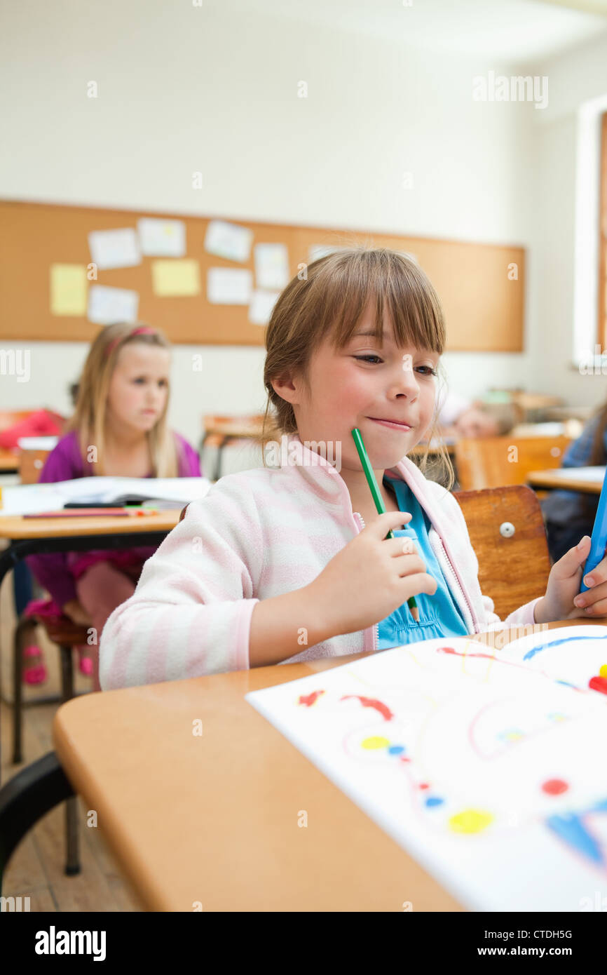 Girl in first row with drawing book Stock Photo - Alamy