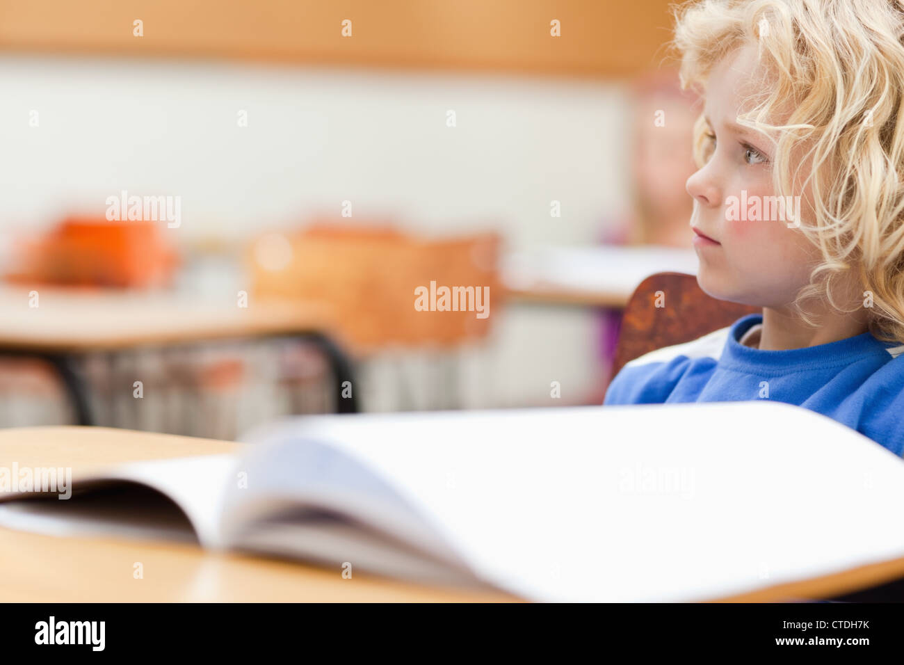 Side view of a boy sitting in class Stock Photo - Alamy