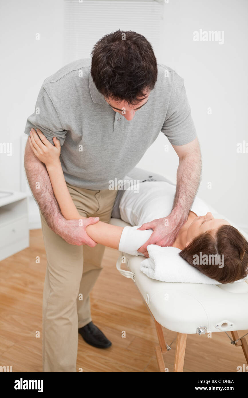 Osteopath working on a shoulder of a patient Stock Photo - Alamy