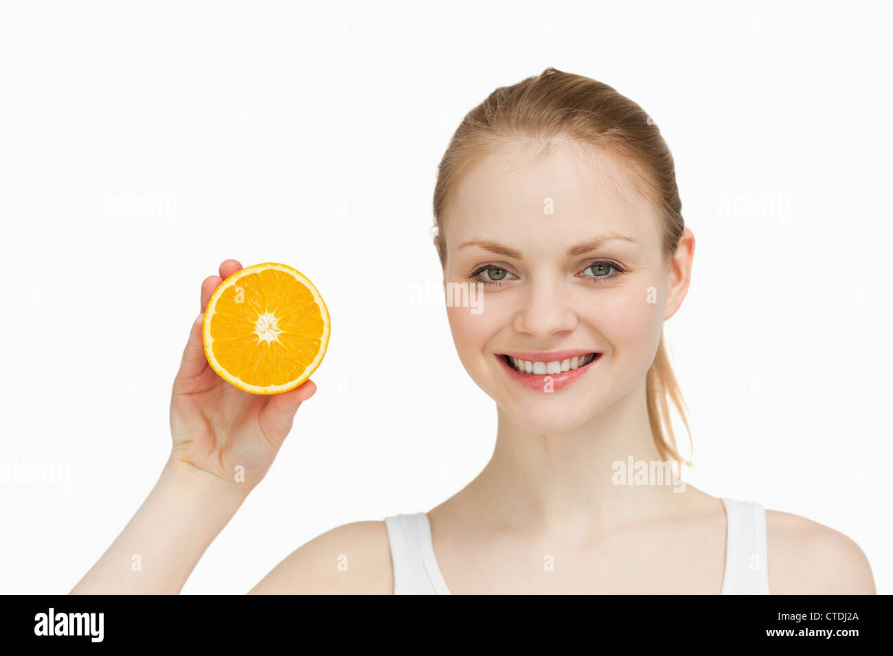 Cheerful woman presenting orange hi-res stock photography and images - Alamy