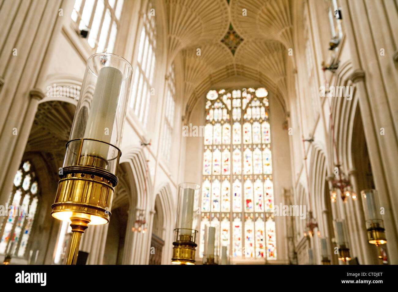 Candles and stained glass windows in Bath Abbey Somerset UK Stock Photo ...