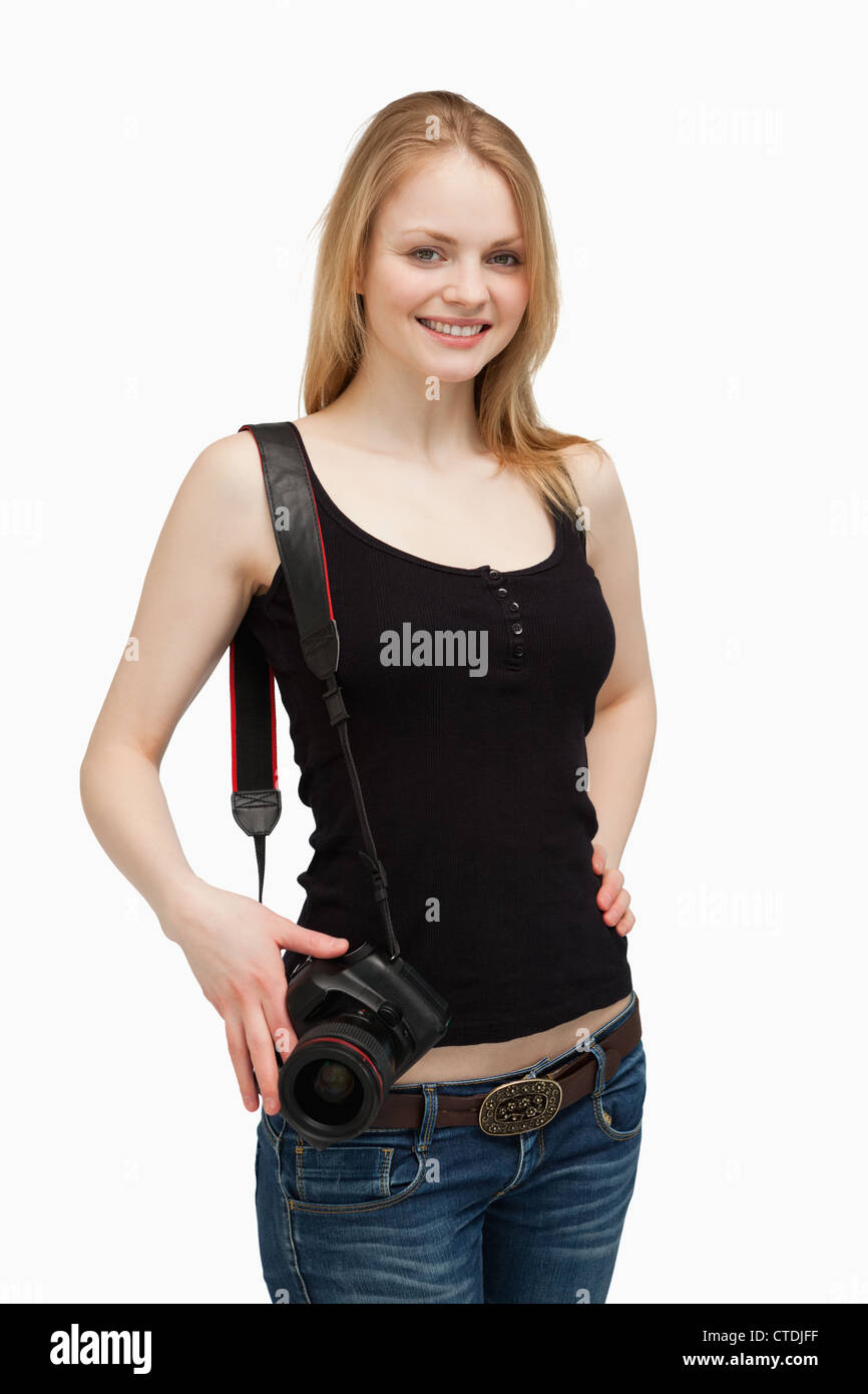 Woman smiling while carrying a camera Stock Photo - Alamy