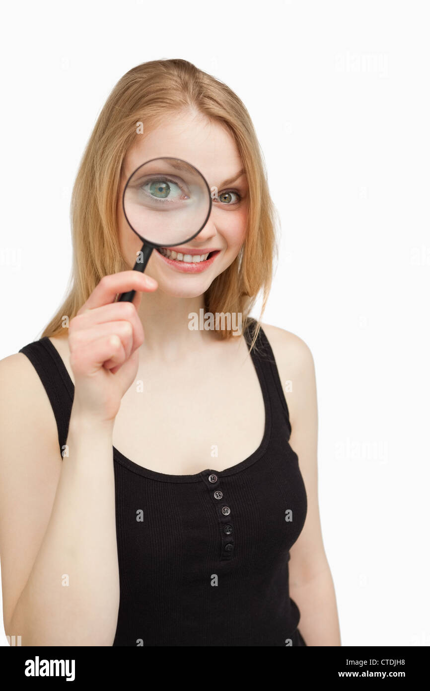Smiling woman using a magnifying glass Stock Photo - Alamy