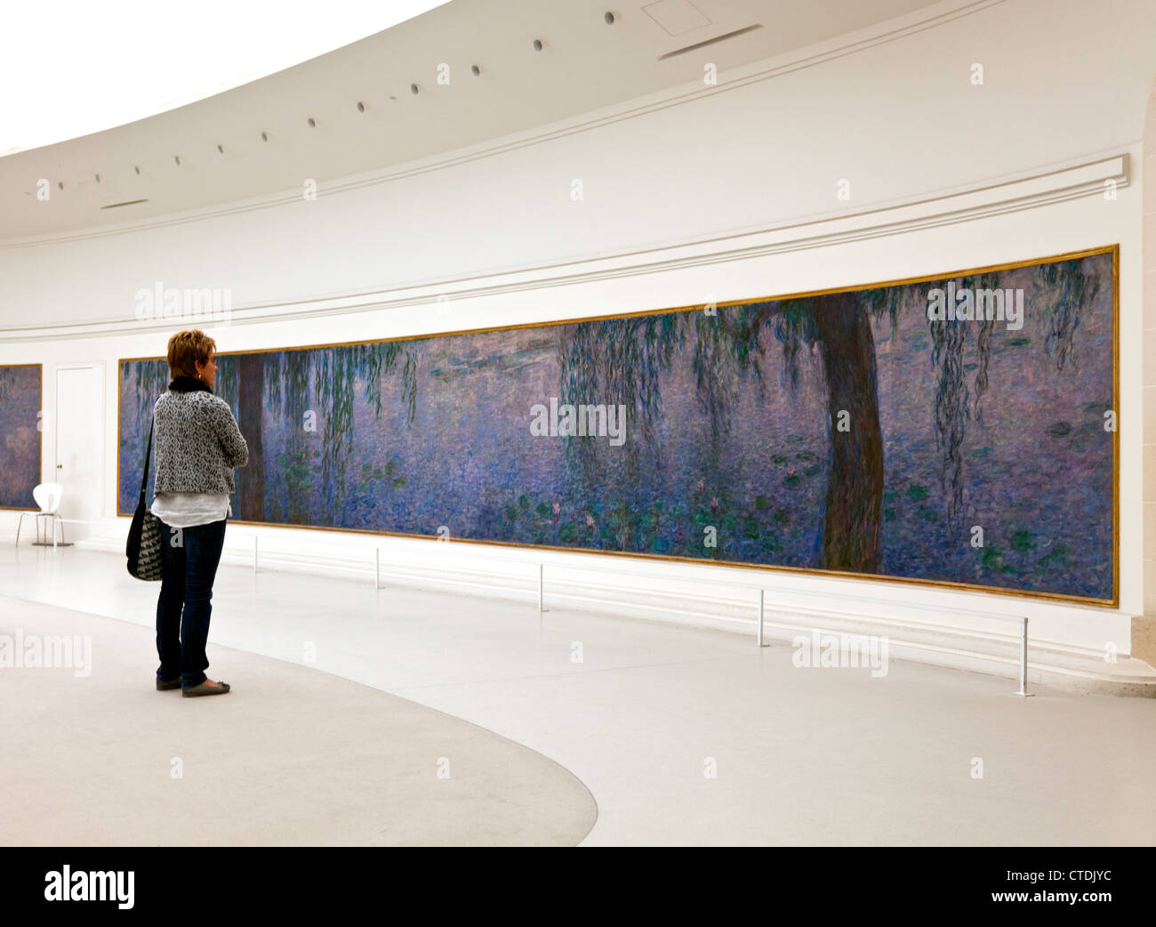 Woman viewing one of eight "Nympheas" (Monet's Water Lilies murals) at ...