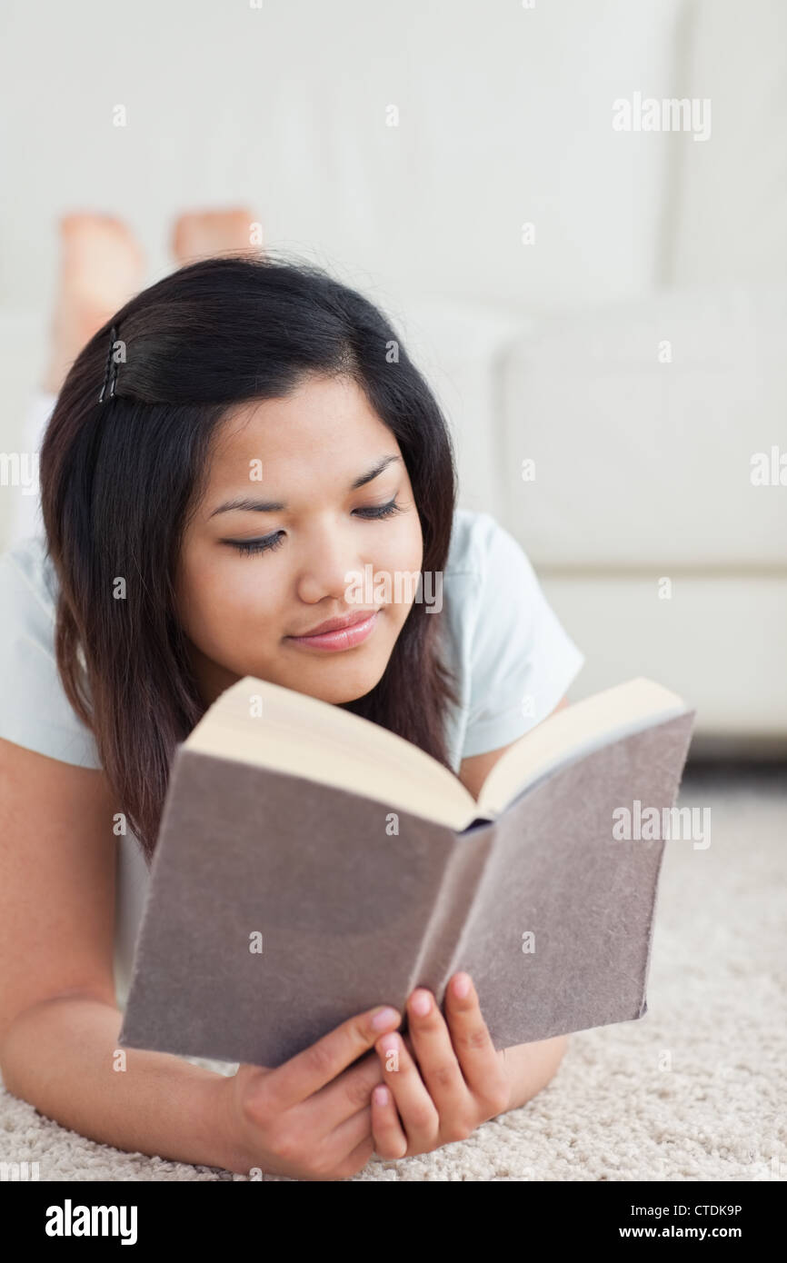 Woman lying on the floor and reading a book Stock Photo - Alamy