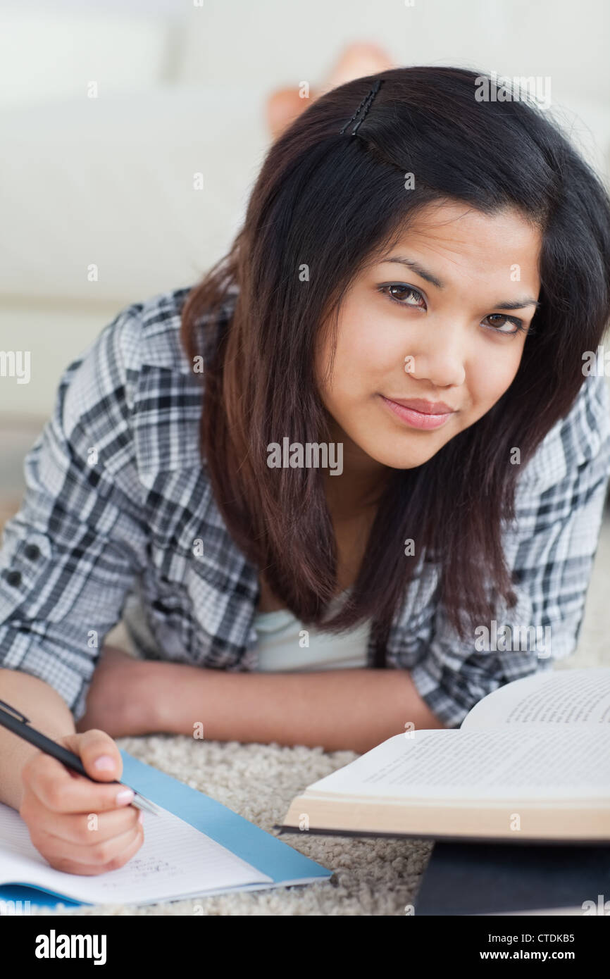 Woman laying on the floor while writing on a notebook Stock Photo - Alamy