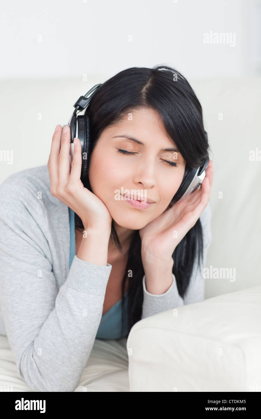 Woman sitting on couch closing hi-res stock photography and images - Alamy
