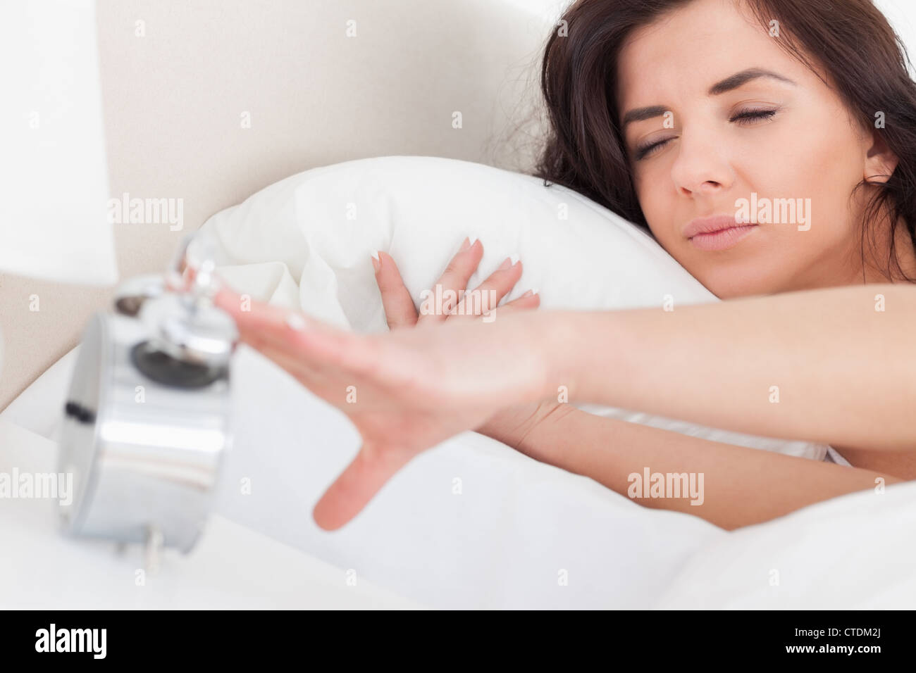 Woman switching off alarm clock hi-res stock photography and images - Alamy