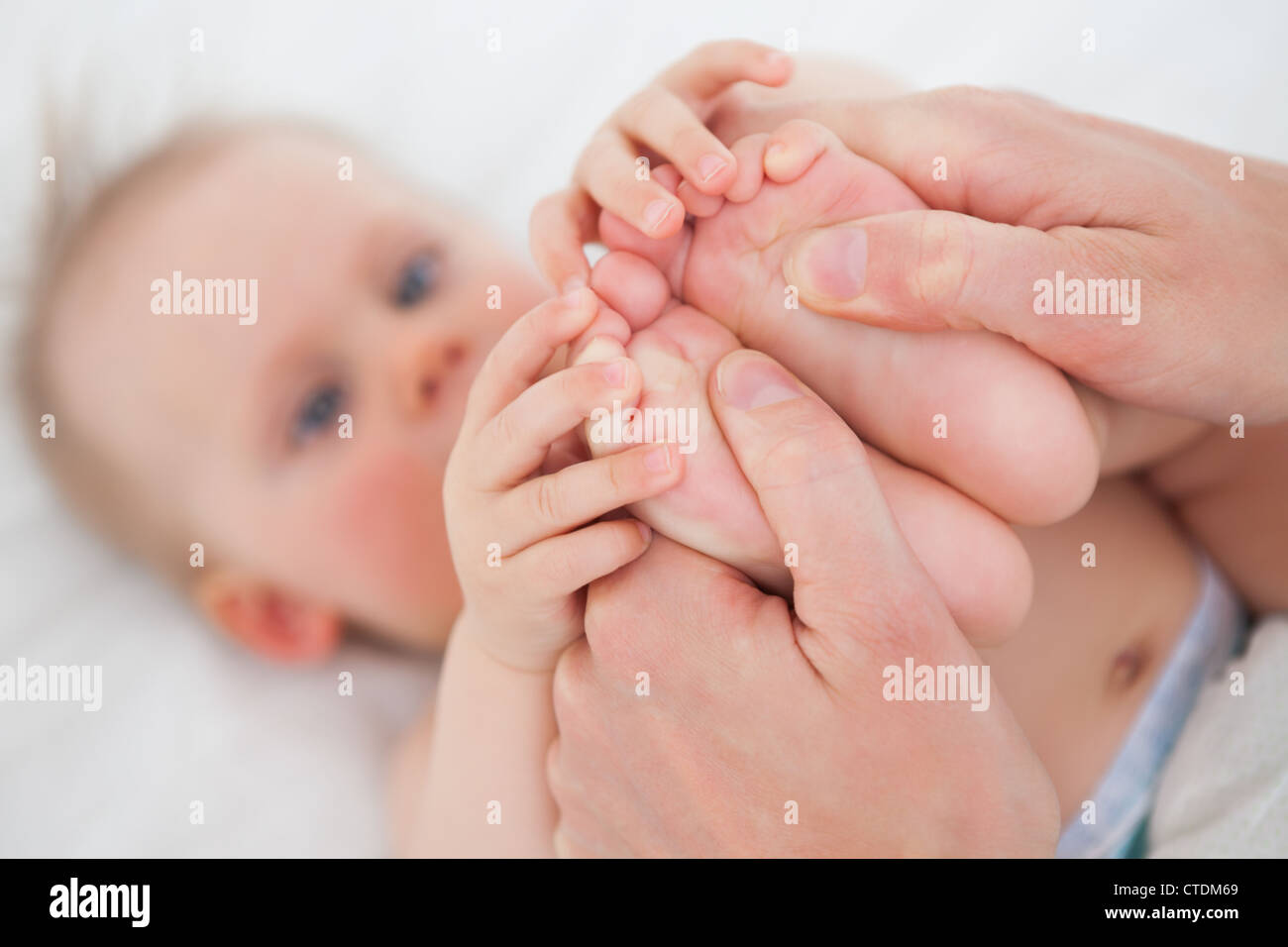 Feet of a cute little girl being held Stock Photo - Alamy