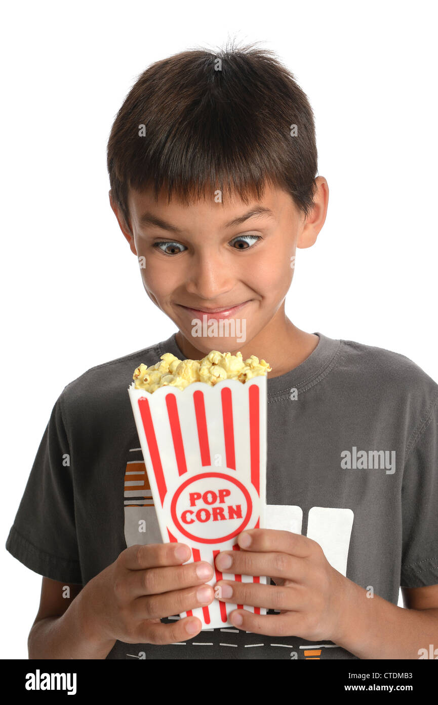 Portrait of young boy making faces holding popcorn isolated over white ...