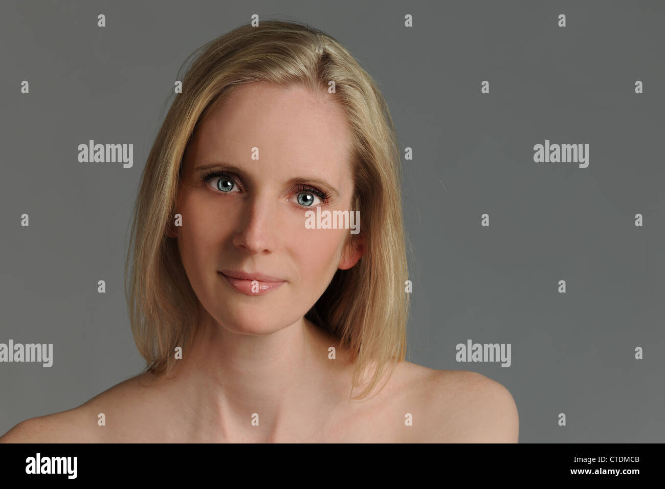 Portrait of beautiful woman over neutral background Stock Photo - Alamy