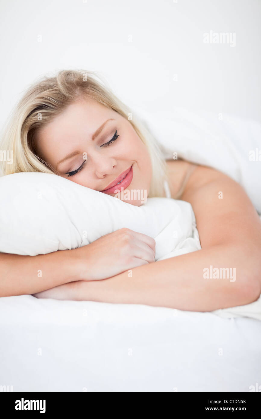 Young woman smiling while sleeping Stock Photo - Alamy