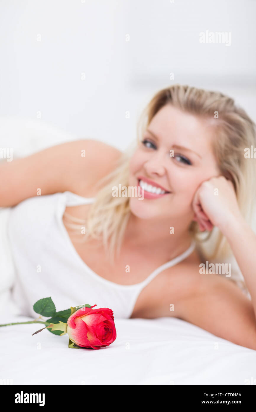 Young woman with a rose smiling Stock Photo - Alamy