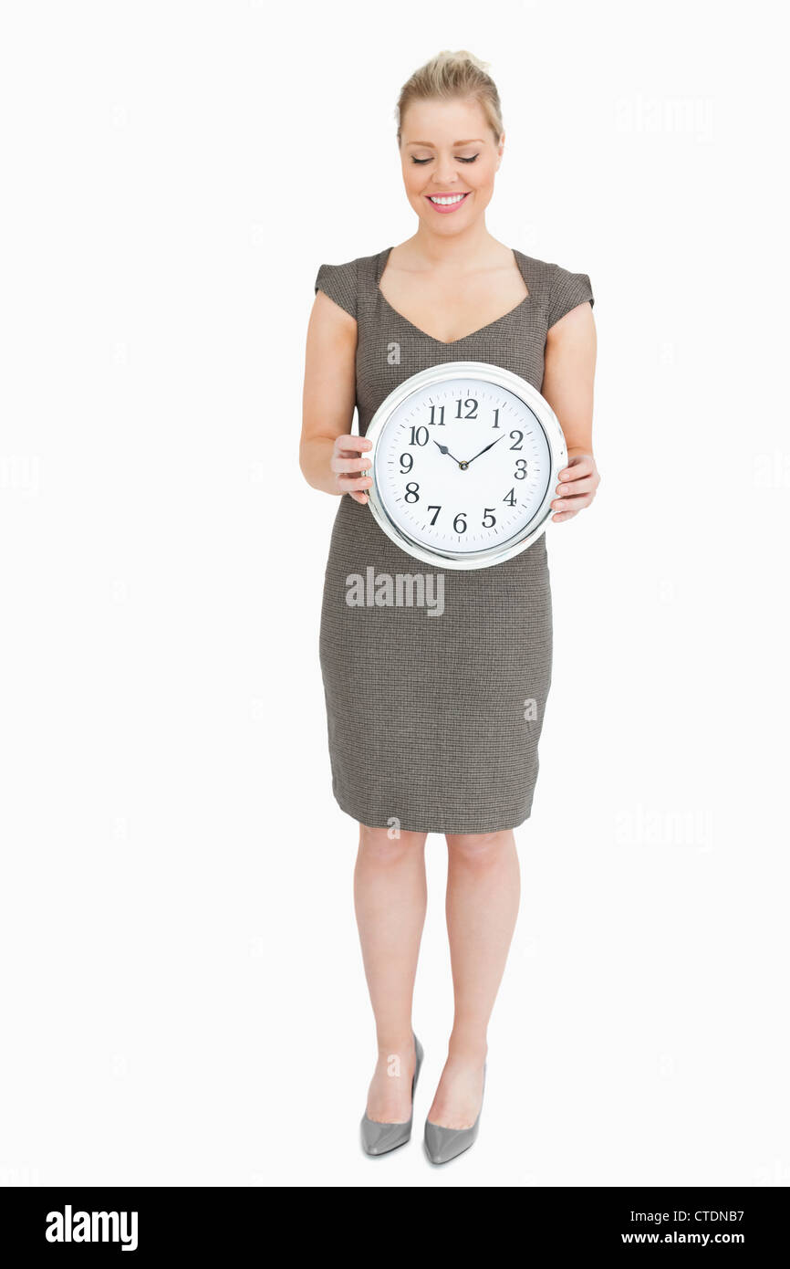 Woman showing a clock Stock Photo - Alamy