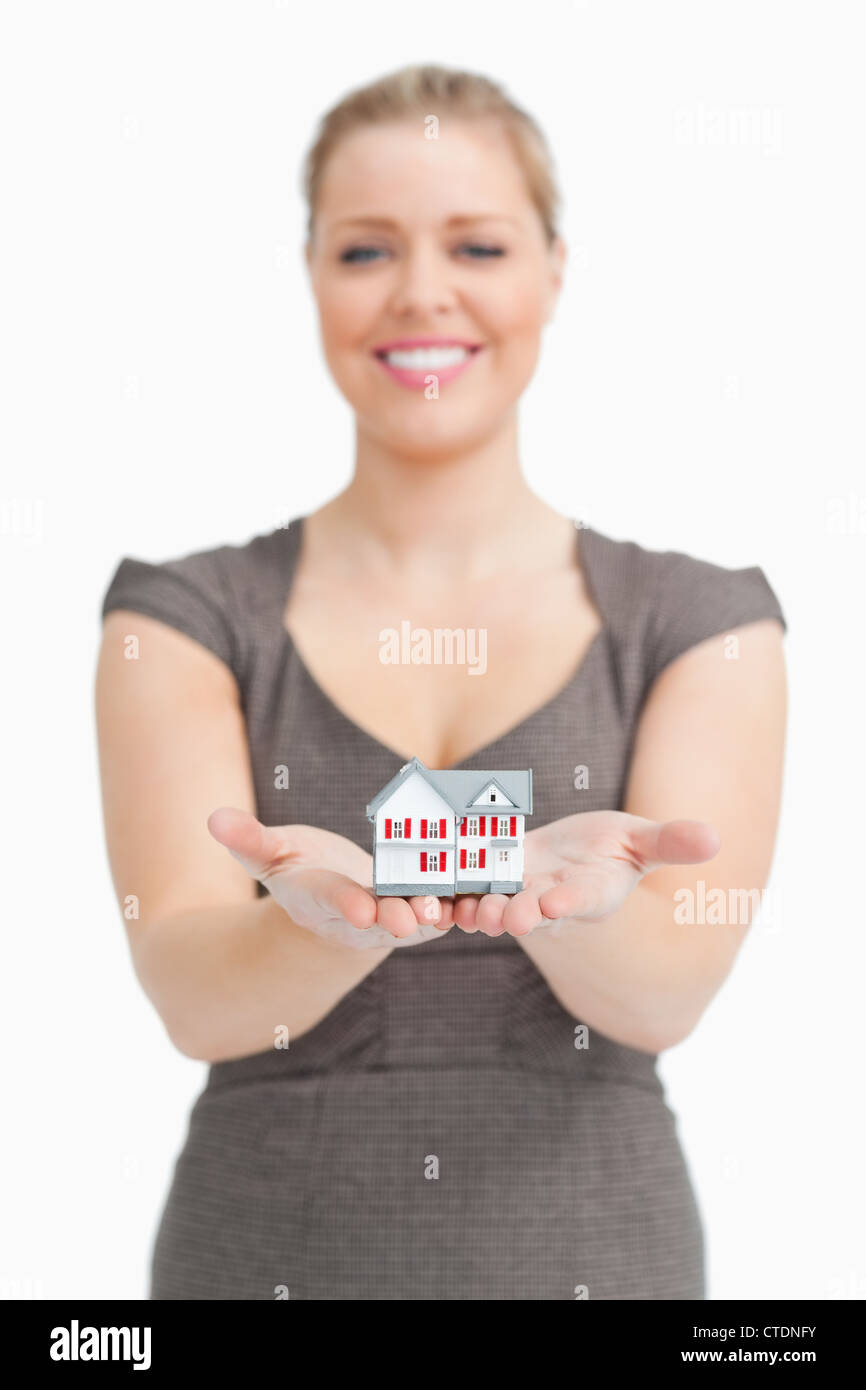 Woman showing a little model house Stock Photo - Alamy