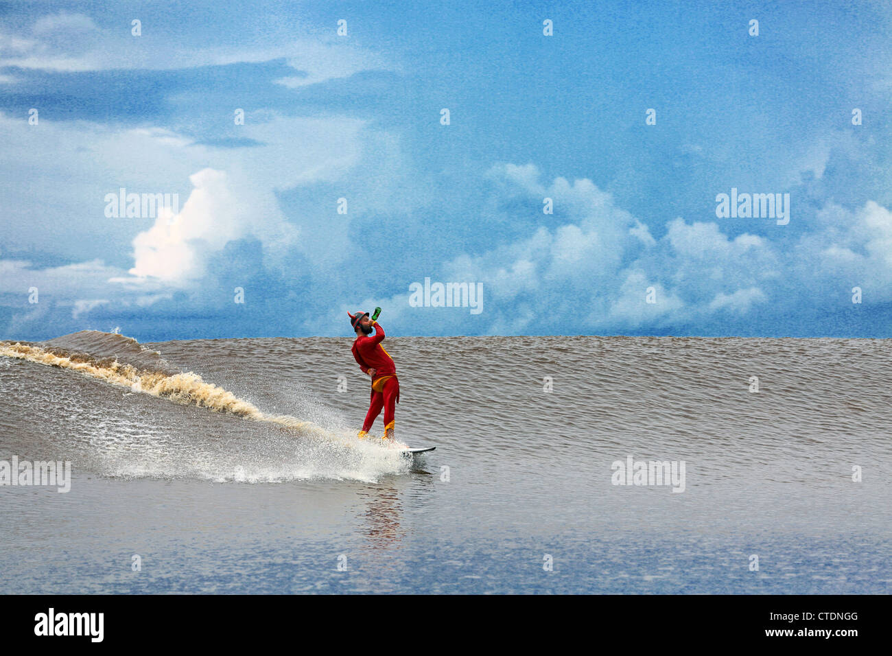 Tourist in red suit drinking beer while tidal bore surfing on the ...