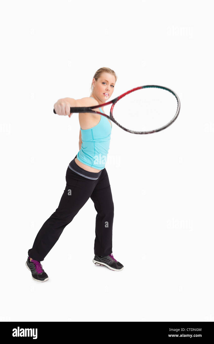 Woman playing tennis with a racket Stock Photo - Alamy