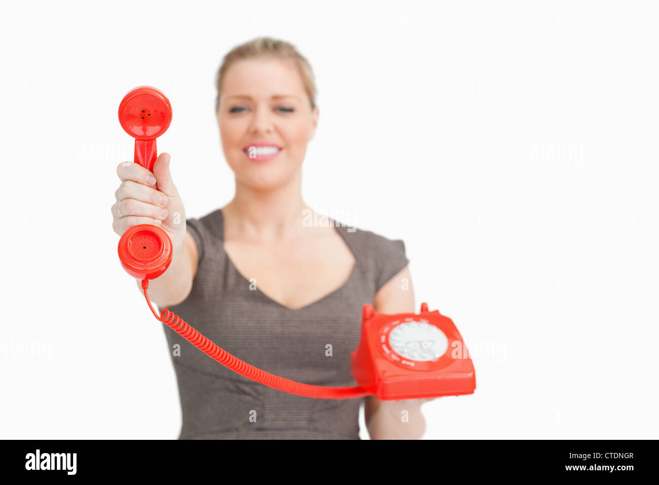 Woman showing a red retro phone Stock Photo - Alamy