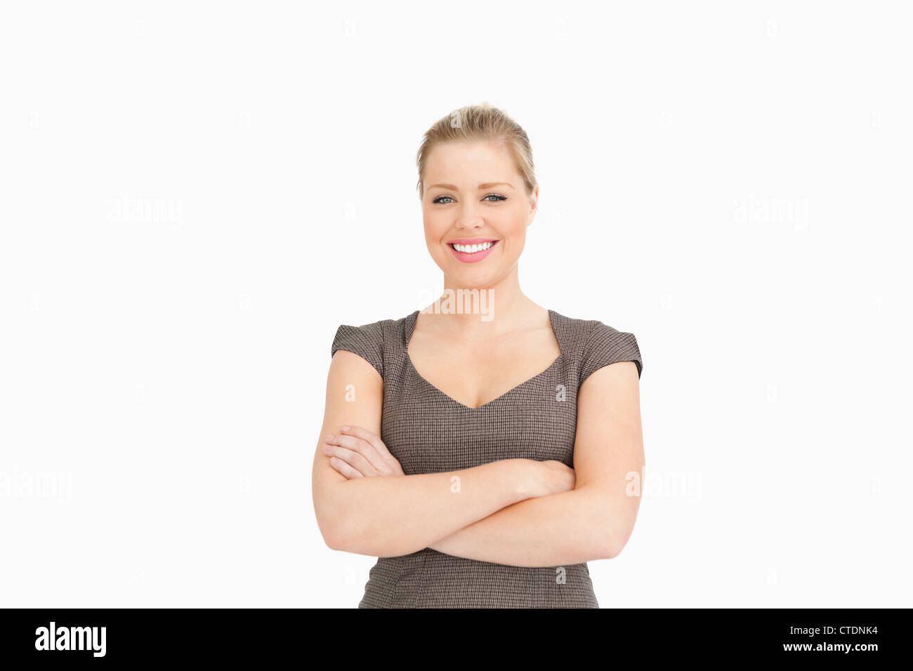 Woman smiling with her arms crossed Stock Photo - Alamy