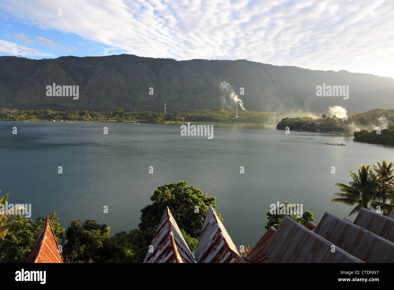 The peaked roofs of traditional Batak houses visible overlooking Bagus ...