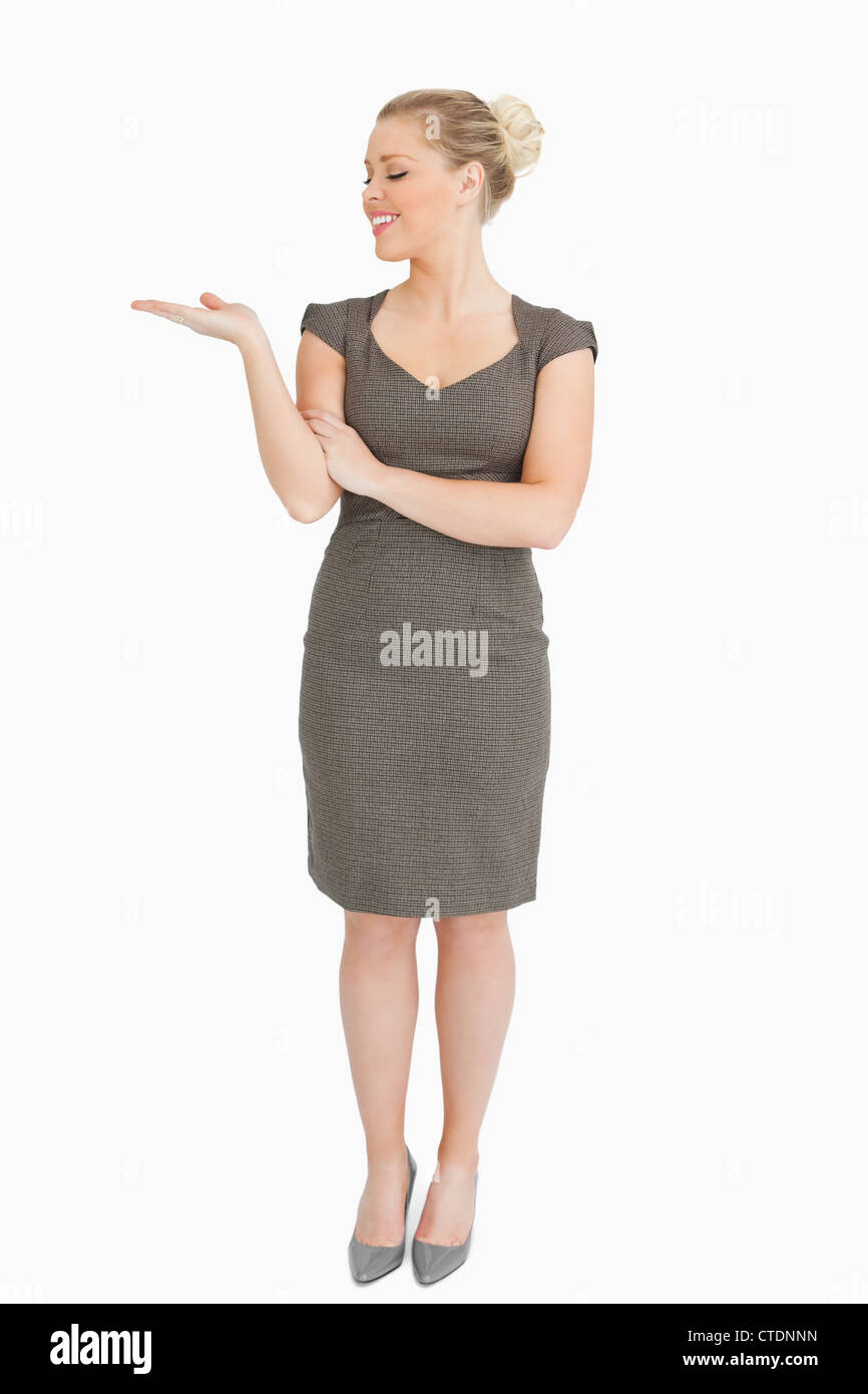 Woman looking her hand presenting something Stock Photo - Alamy