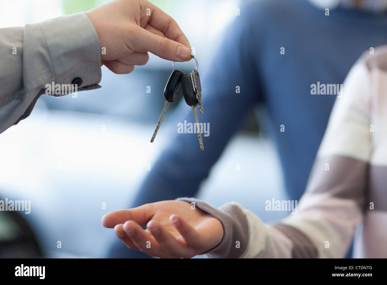 Car dealer giving keys to a customer Stock Photo - Alamy
