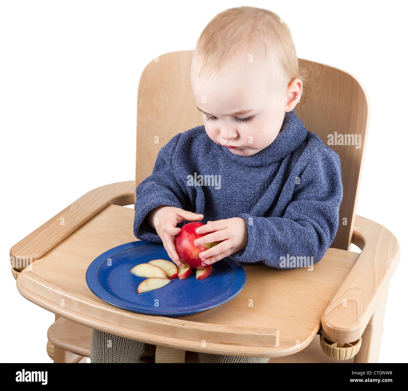 young child eating in high chair isolated in white background Stock ...