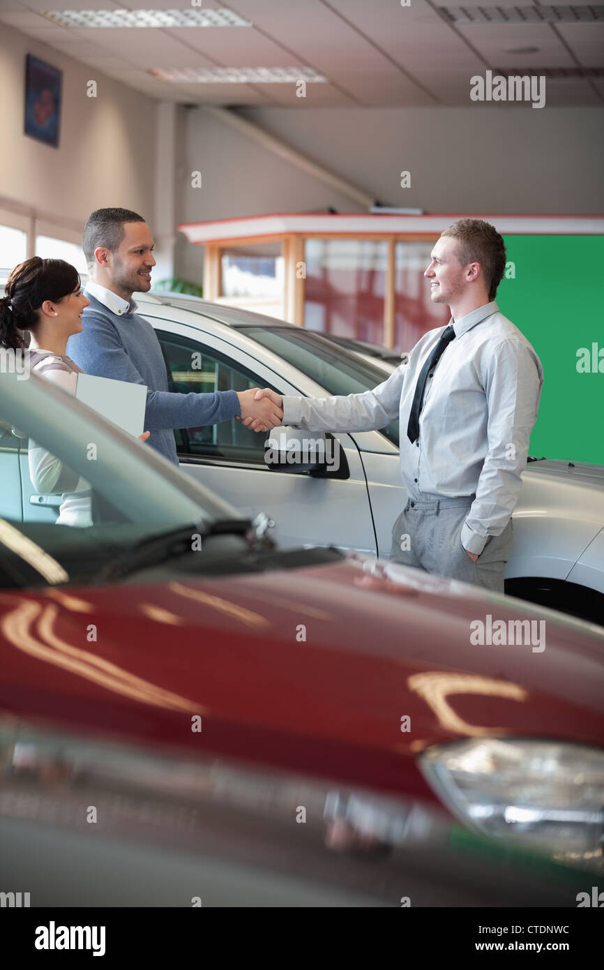 Man shaking the hand of a salesman Stock Photo - Alamy