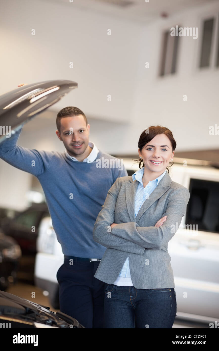 Happy couple in front of an open engine Stock Photo - Alamy