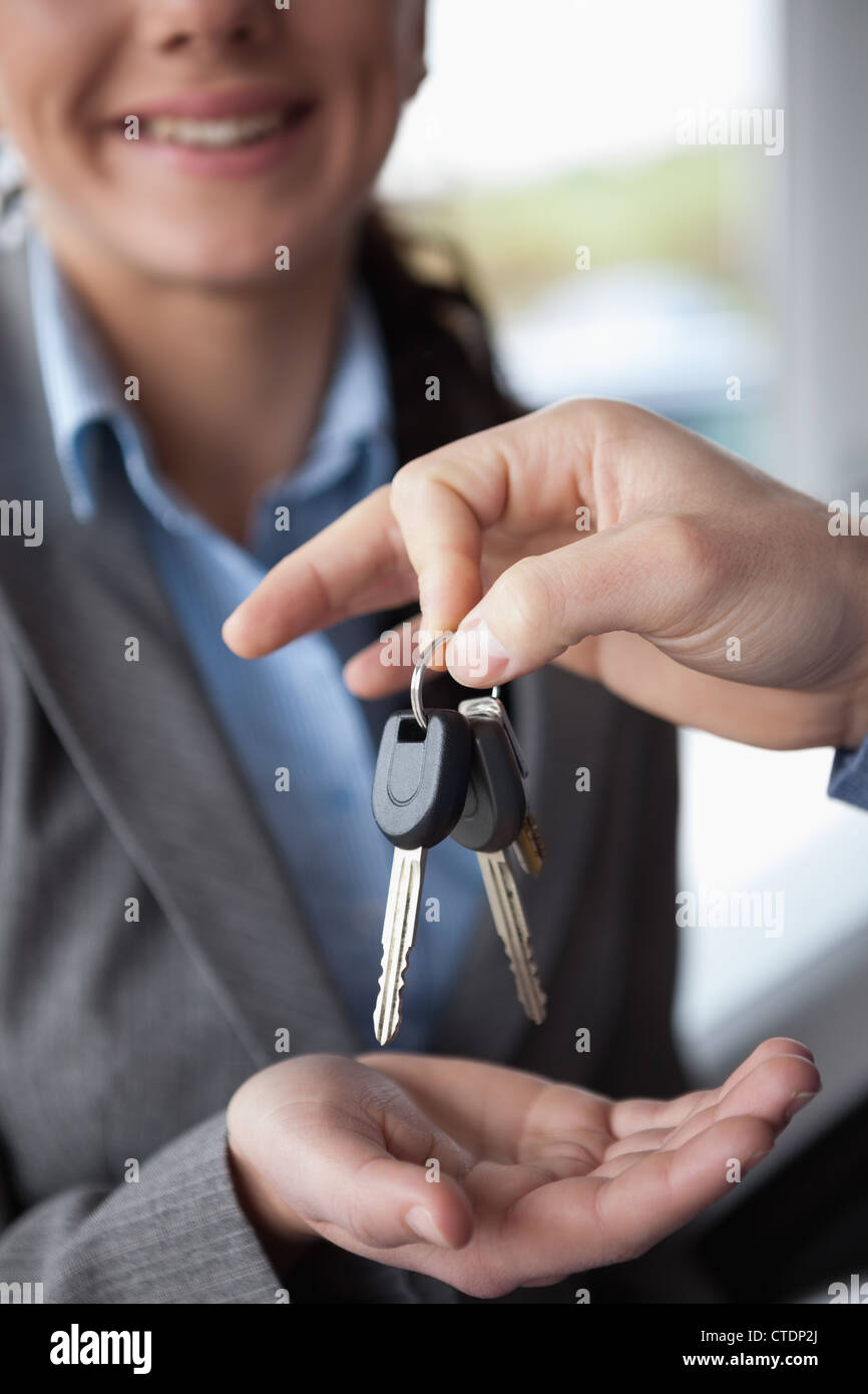 Hand holding keys over the hand of a woman Stock Photo - Alamy