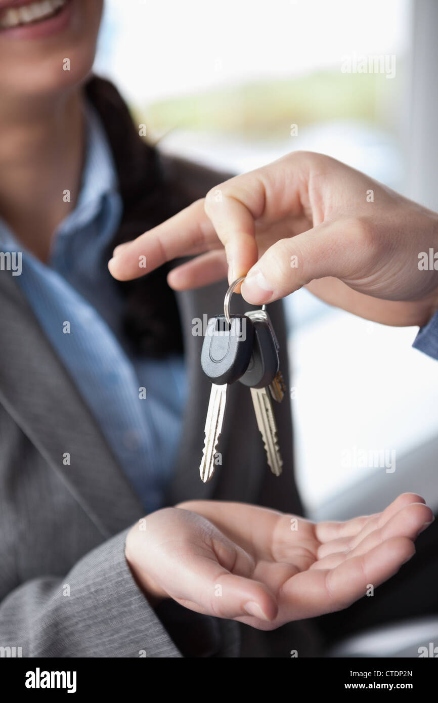 Woman smiling while receiving keys Stock Photo - Alamy