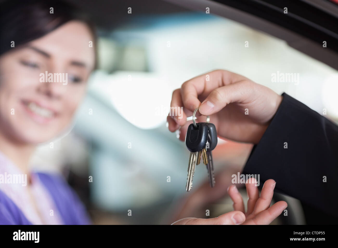 Woman in a car receiving keys Stock Photo - Alamy
