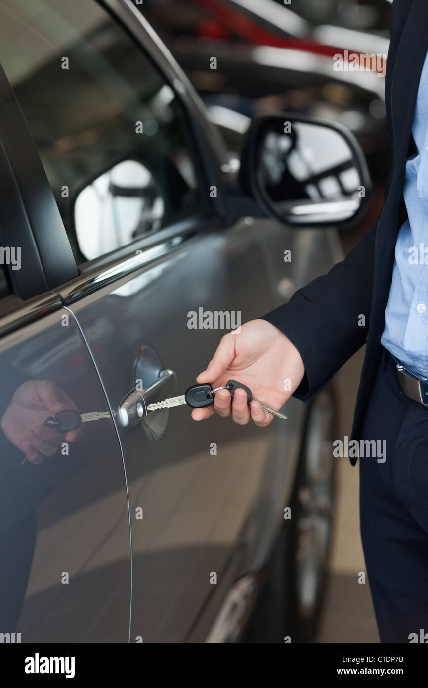 Man opening a car with a key Stock Photo - Alamy