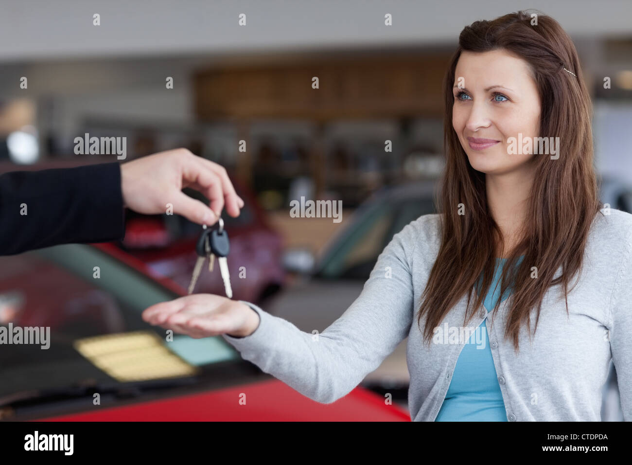 Woman receiving car keys in his hand Stock Photo - Alamy