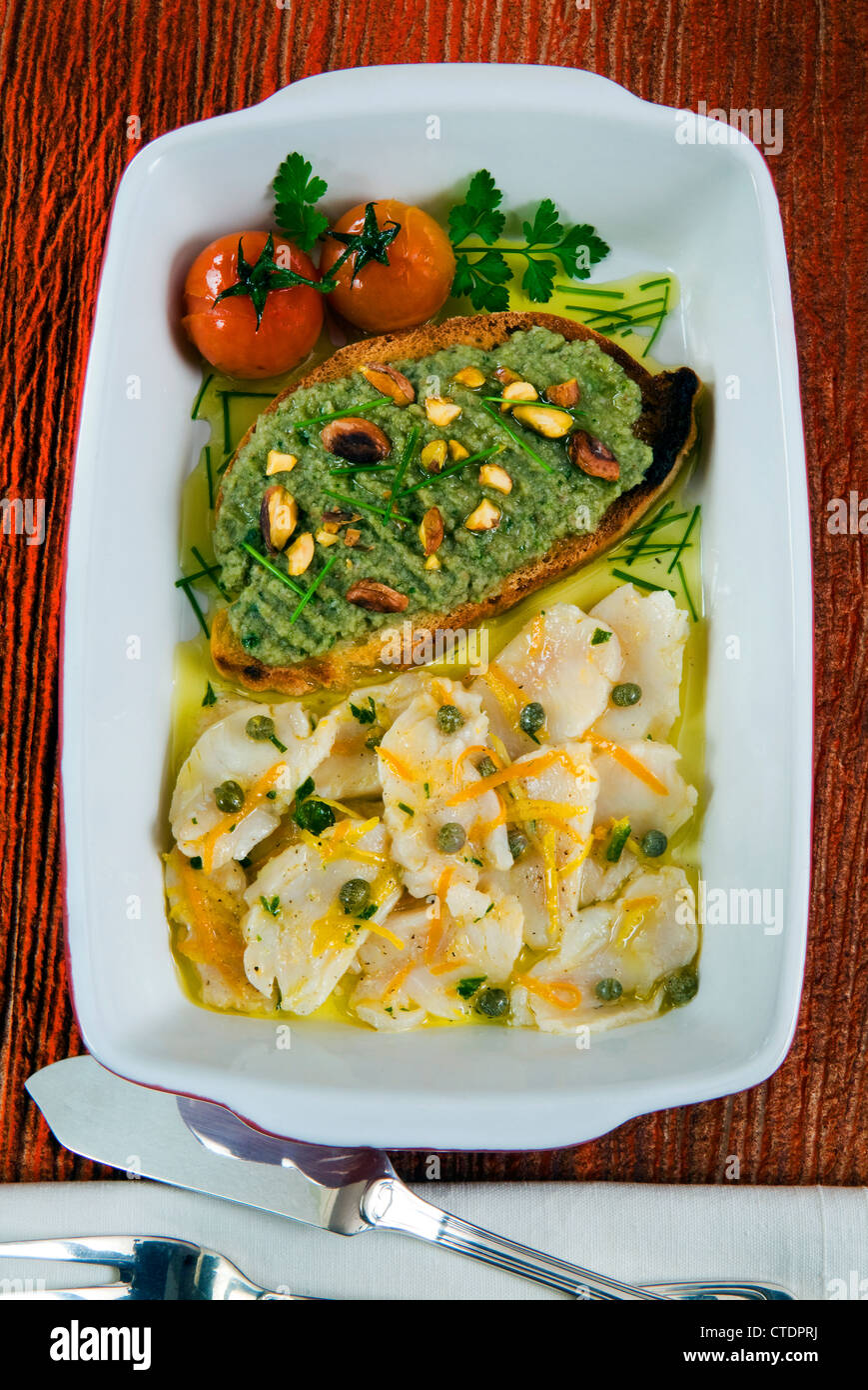 Cod carpaccio (carpaccio is a dish of raw meat or fish) with tomatoes ...