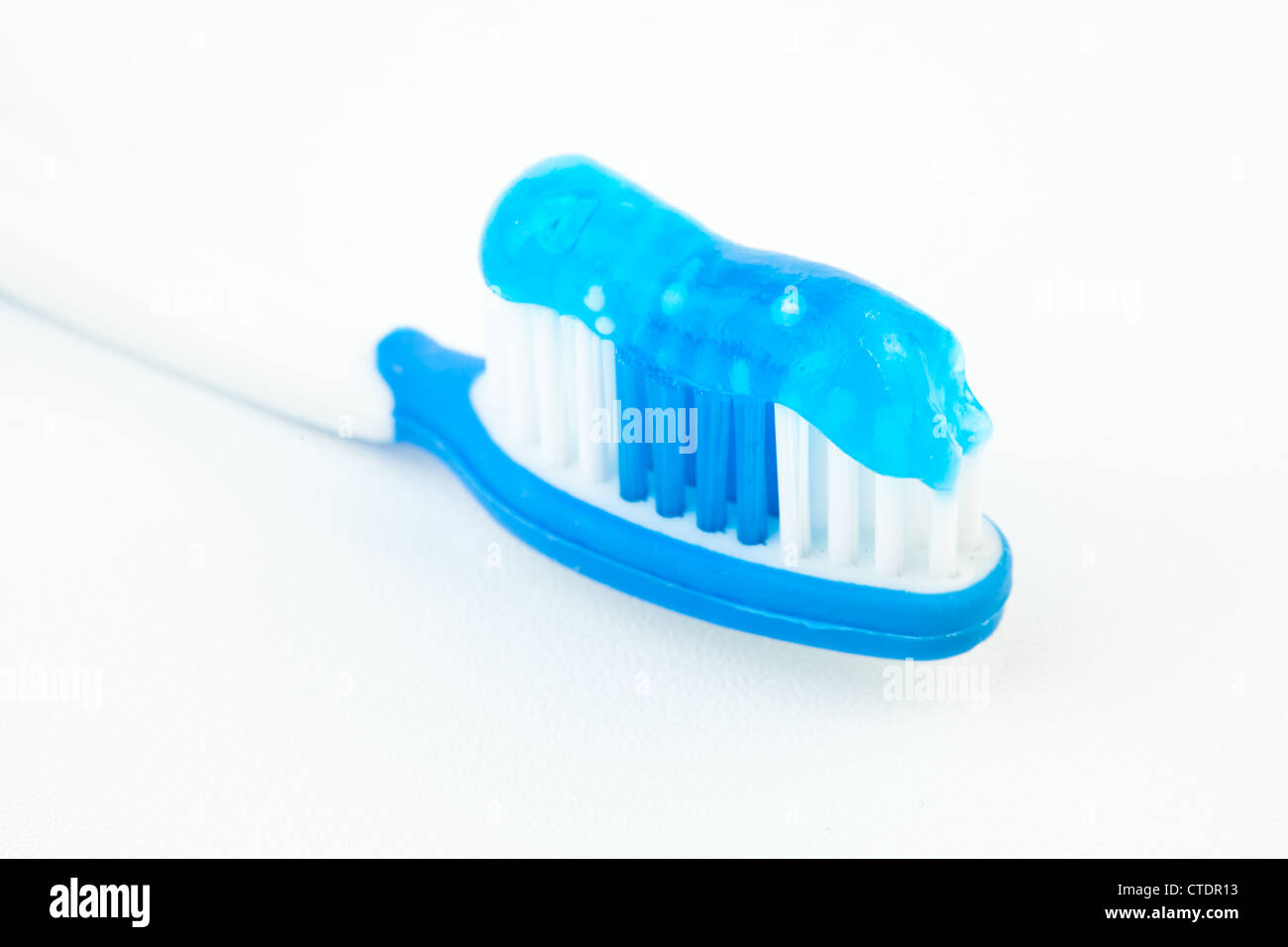 Toothbrush with blue toothpaste Cut Out Stock Images & Pictures - Alamy