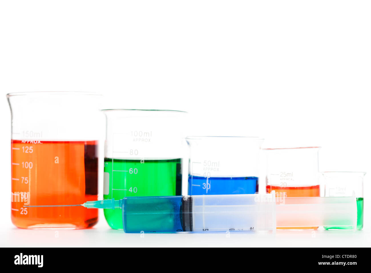 Five beakers behind a syringe Stock Photo - Alamy