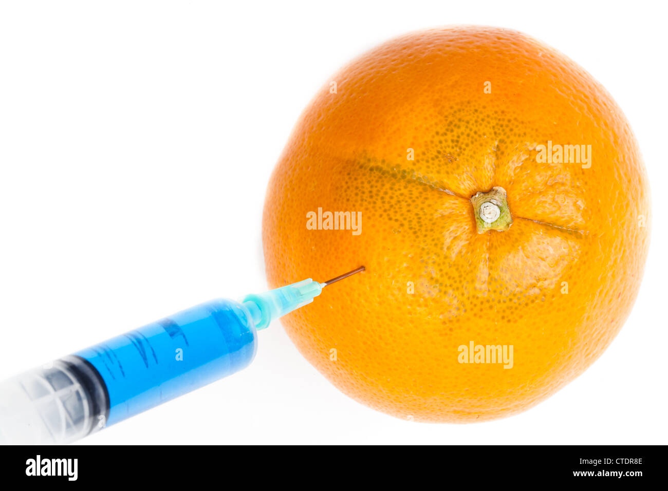 Syringe injecting in an orange Stock Photo - Alamy