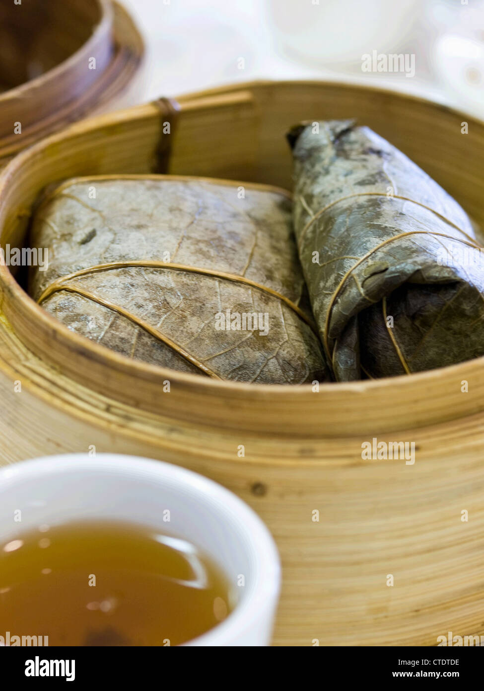 Steamed Chinese rice dumplings wrapped in bamboo leaves Stock Photo - Alamy