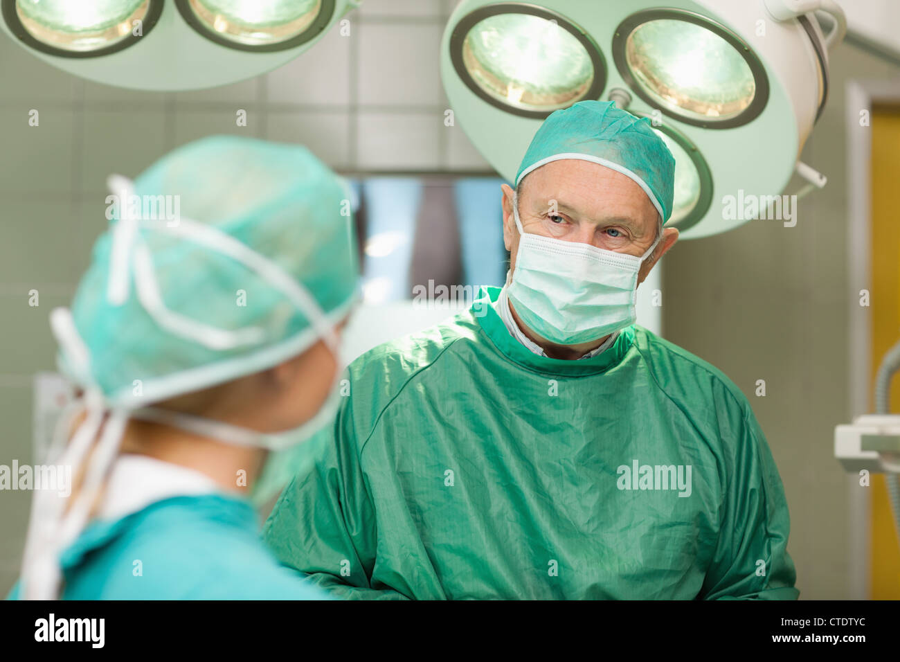 Two surgeons looking at each other Stock Photo - Alamy