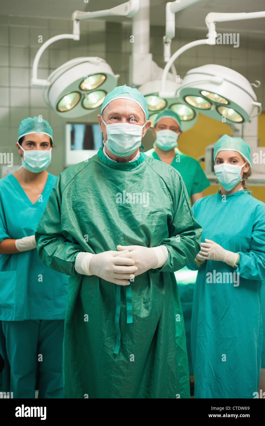 Smiling surgeon posing with a medical team Stock Photo - Alamy