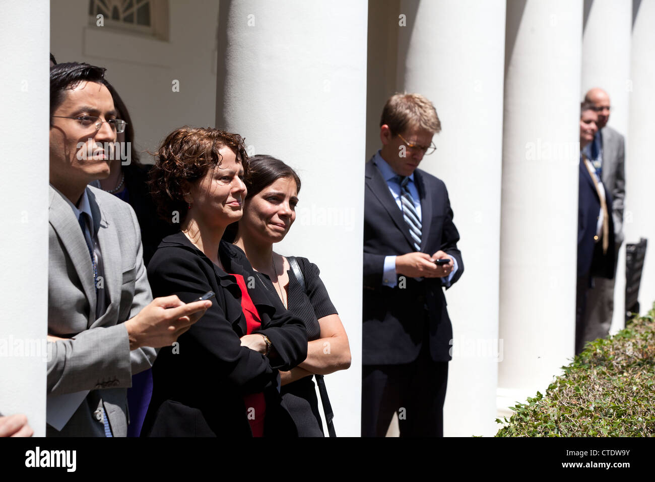 White House staff members listen from the Colonnade of the White House ...