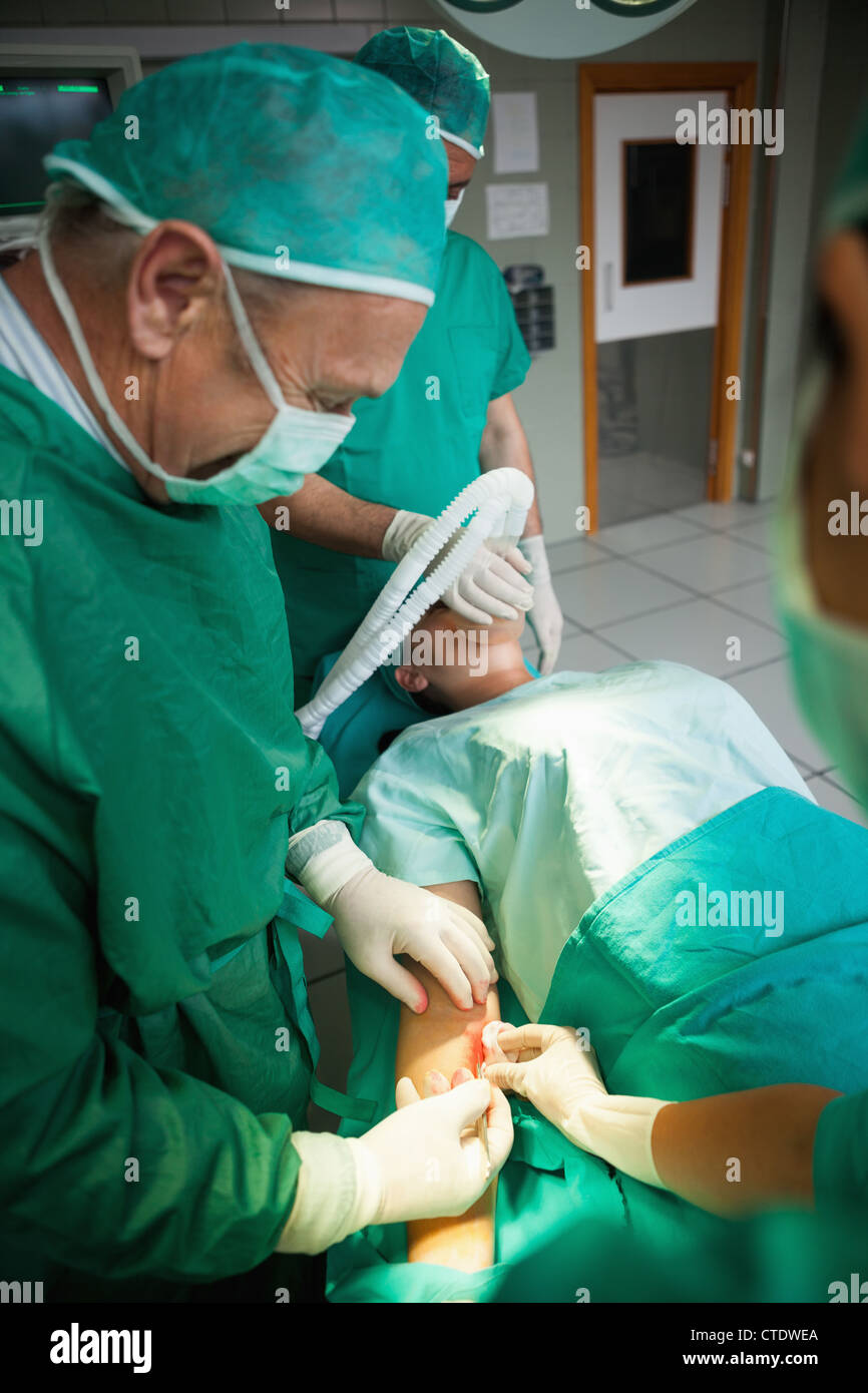 Surgeon using a scalpel to open a patient Stock Photo - Alamy
